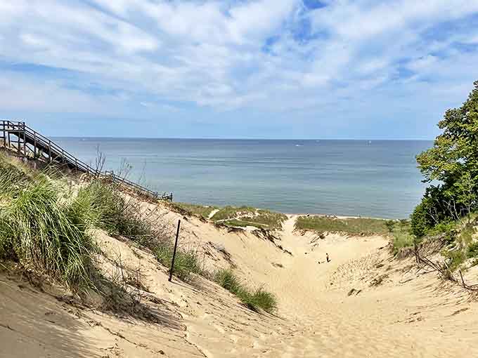 The reward for conquering those stairs? Miles of golden sand meeting Caribbean-blue waters that make you question whether you're still in Michigan.
