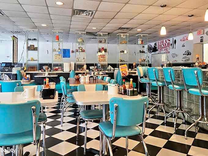 Step inside and the checkerboard floor practically does the twist beneath your feet, while turquoise chairs invite you to settle in for comfort food bliss.