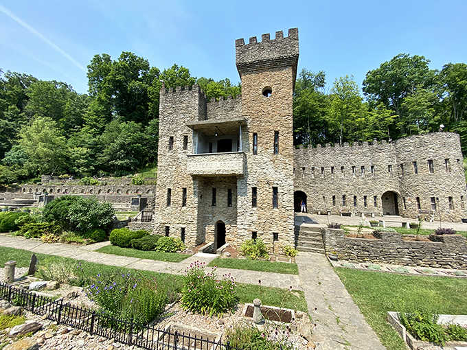 The castle's imposing front view showcases authentic medieval architecture with its defensive tower and meticulously crafted stonework.