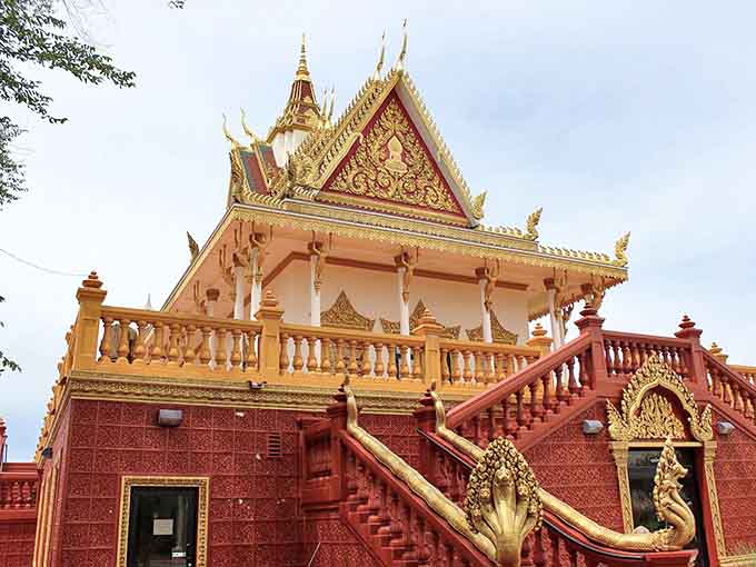 The temple's side view reveals layers of architectural poetry &ndash; each tier and curve telling stories of ancient traditions finding new roots in American soil.