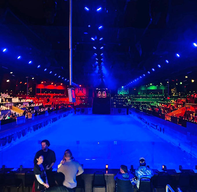 The arena glows like a medieval disco, proving that the Dark Ages could've used better lighting designers all along.