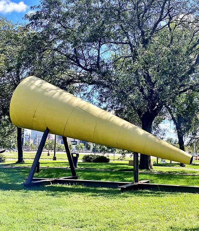 This yellow megaphone sculpture seems to be eavesdropping on the neighborhood &ndash; art with ears!