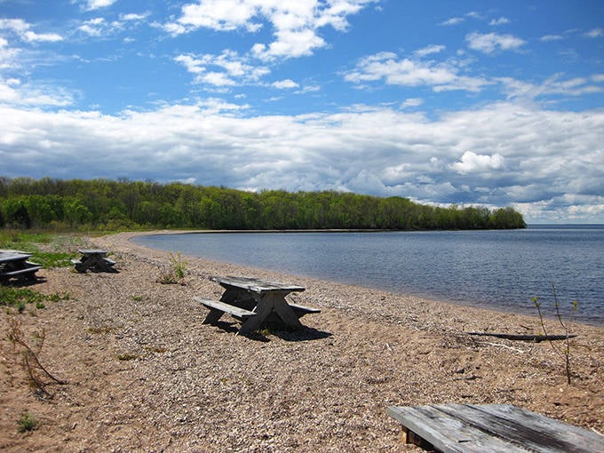 Rustic picnic tables await adventurous souls, offering front-row seats to nature's theater without the typical crowd.