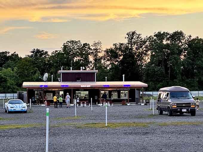 The snack bar glows with inviting neon, promising buttery popcorn and sweet treats that taste better somehow when eaten under the stars.