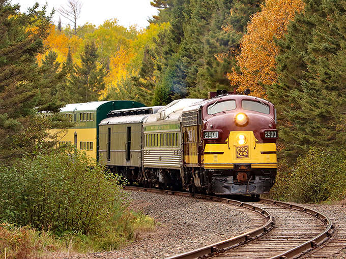 Fall's fiery palette creates a perfect backdrop for the vintage Soo Line train as it curves through Minnesota's northern wilderness.