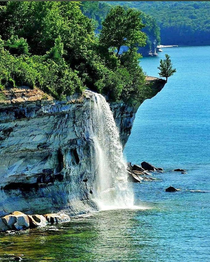 The side view reveals Spray Falls' true power – water plummeting directly into Lake Superior, creating rainbows in the mist when sunlight hits just right.
