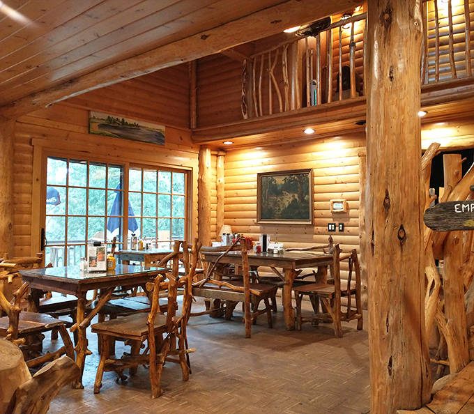 Warm pine walls and handcrafted log furniture create the perfect northwoods dining atmosphere, where comfort meets wilderness charm.