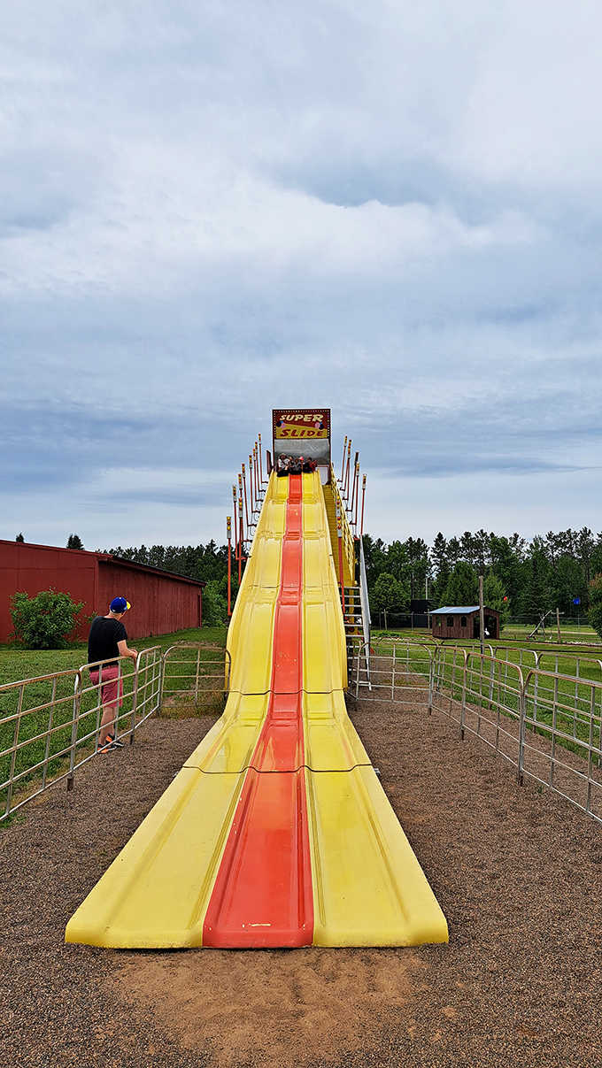 The Super Slide beckons thrill-seekers with its bright yellow lanes and promises of gravity-powered joy.