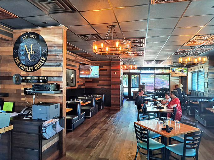 Rustic wood paneling meets modern comfort in this dining space where every table feels like the best seat in the house.