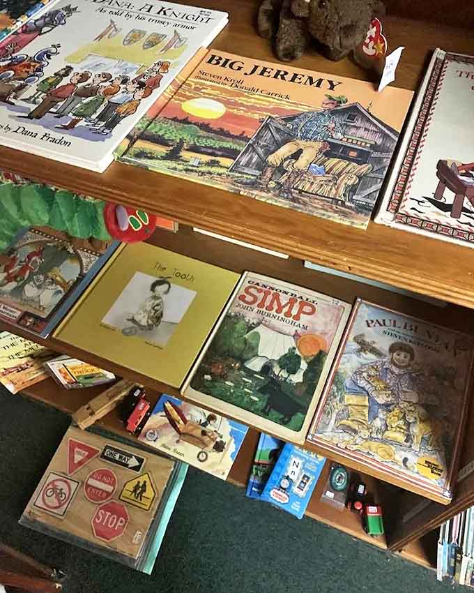 Children's classics line these well-worn shelves, each book a portal to childhood adventures. "Big Jeremy" stands ready to transport another generation to simpler times.