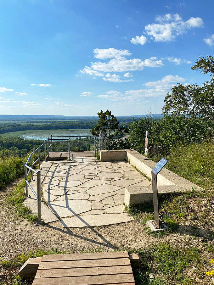 This stone platform isn't just a viewpoint—it's nature's balcony, offering front-row seats to Minnesota's greatest show: the river valley vista.