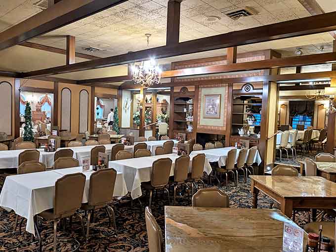 Elegant chandeliers cast a warm glow over the dining room, where generations have gathered for legendary family-style feasts in timeless surroundings.