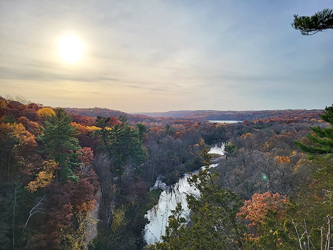 Autumn's canvas unfolds across the Willow River valley, painting the landscape in fiery hues that complement the silver ribbon of water below.
