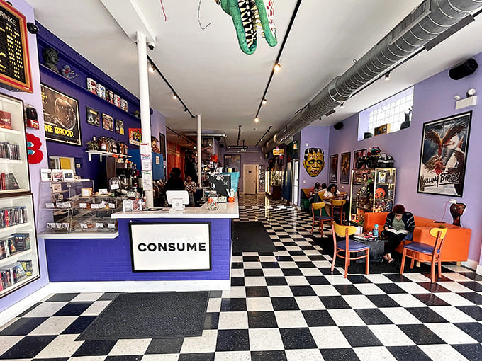 Black and white checkered floors lead you into a purple-walled wonderland where horror memorabilia and coffee culture collide in delicious harmony.