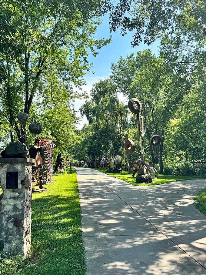 The sculpture-lined entrance beckons visitors into a world where industrial waste transforms into fantastical art under Wisconsin's open sky.
