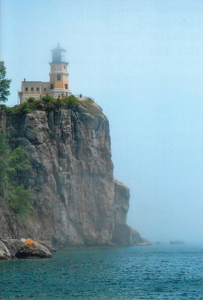 Shrouded in mysterious fog, the lighthouse emerges like a ghost ship on land. Even in limited visibility, its steadfast presence commands respect from Lake Superior's unpredictable waters.
