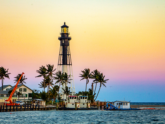Mother Nature showing off her sunset palette, painting the sky in warm hues that make the lighthouse's silhouette pop like a maritime celebrity.