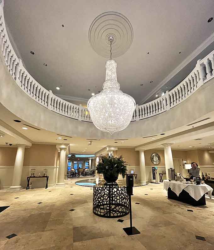 The lobby's spectacular crystal chandelier commands attention, suspended above marble floors that whisper "you've arrived somewhere special."