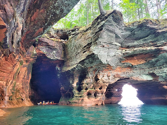Nature's cathedral: Sunlight streams through an ancient sea cave opening, illuminating turquoise waters that would make Caribbean beaches jealous.