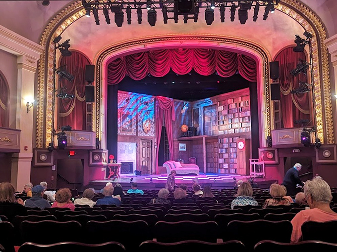 Step inside and gasp at the ornate interior where crystal chandeliers cast a warm glow over the stage, instantly transporting you to a more glamorous era.