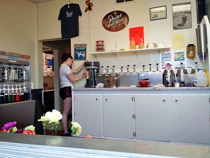 Behind the counter, magic happens as staff prepare to create towering soft serve masterpieces that defy both gravity and self-control.