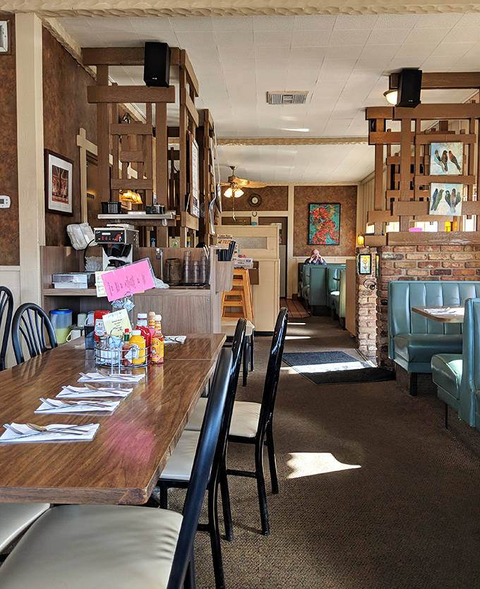 Wood paneling, cozy dividers, and warm lighting create that perfect "grandma's dining room" vibe where comfort begins before the food even arrives.