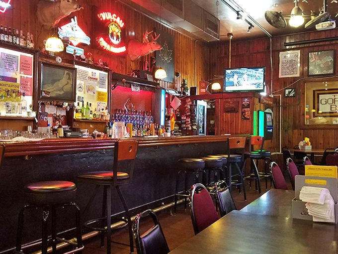 Wood-paneled walls and well-worn bar stools tell stories of countless conversations, cold beers, and Coney dogs devoured in this authentic Minnesota institution.