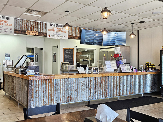 Rustic charm meets BBQ authenticity with corrugated metal accents and award banners proudly displayed above the welcoming counter.