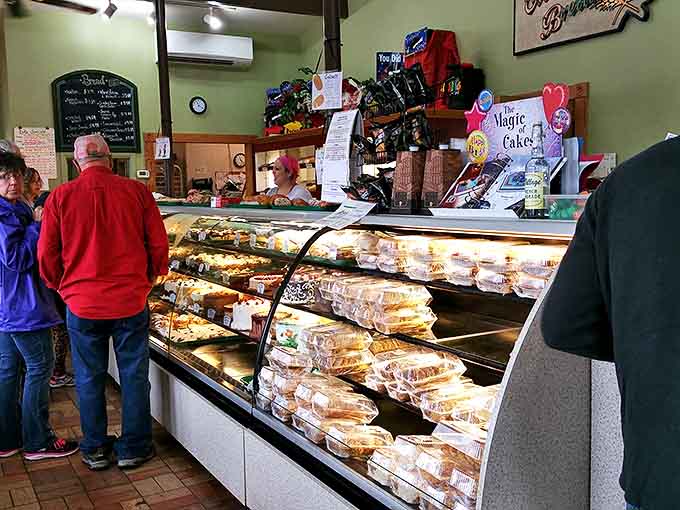 Inside, the bakery buzzes with anticipation as customers eye the display cases, each filled with temptations that make diets disappear.