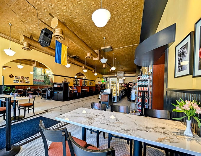 Warm lighting, ornate tin ceilings, and comfortable seating create the perfect backdrop for savoring traditional Eastern European cuisine.