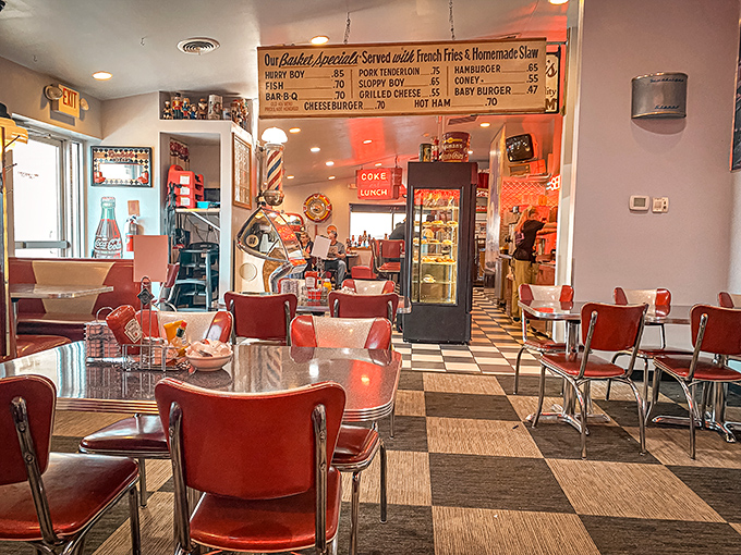 The diner's interior is a masterclass in nostalgic design – checkerboard floors, vintage Coca-Cola signs, and that glowing "SERVICE" neon creating the perfect retro atmosphere.