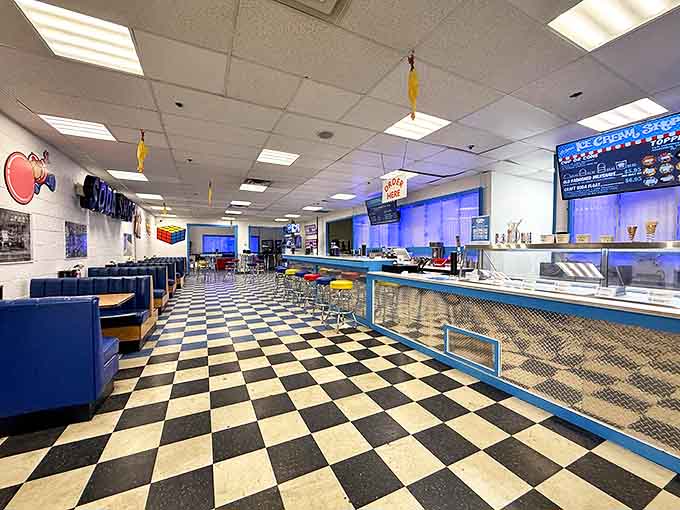 Classic black and white checkered floors meet vibrant blue booths, creating a retro wonderland where calories don't count and nostalgia flows freely.