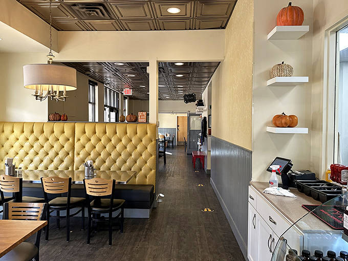 Golden tufted booths invite lingering conversations while metallic ceiling tiles add vintage charm to this cozy Saint Paul gathering spot.