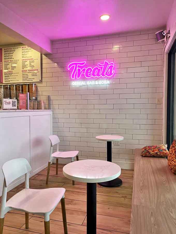Bathed in pink neon glow, the minimalist interior creates the perfect backdrop for colorful creations, like a blank canvas awaiting sugary masterpieces.
