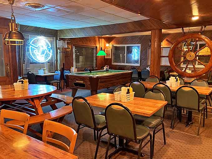 Wooden paneling, ship's wheel, and pool table create the perfect maritime hangout &ndash; like dining in the cozy cabin of your favorite uncle's fishing boat.