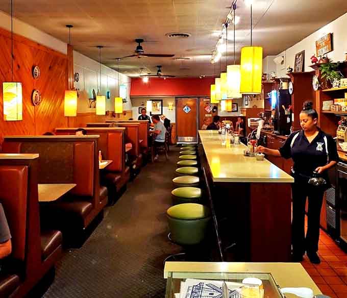 Inside, time stands still in the best possible way &ndash; warm wood paneling, cozy booths, and yellow pendant lights create the perfect backdrop for breakfast bliss.