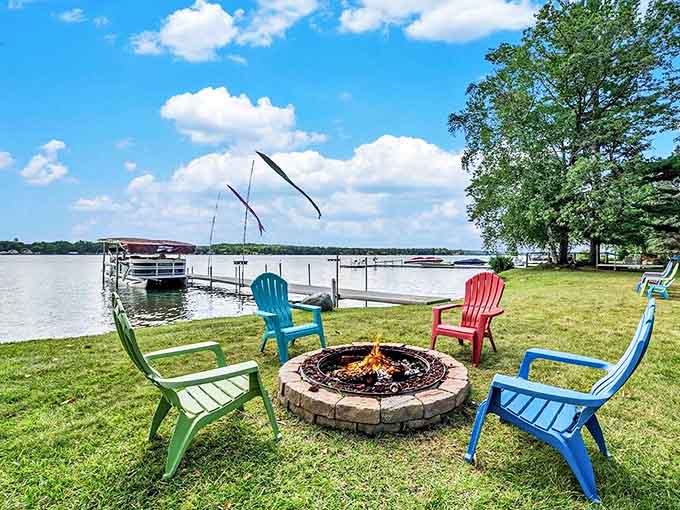 Colorful Adirondack chairs surround a lakeside fire pit, nature's perfect gathering spot for sunset watching and marshmallow sacrificing.