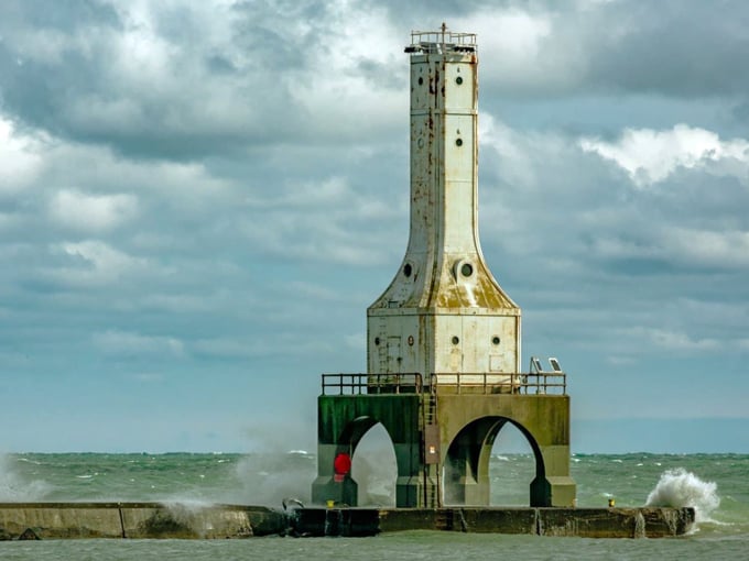 The iconic Port Washington lighthouse stands sentinel at the harbor entrance, weathering Lake Michigan's moods with stoic grace.