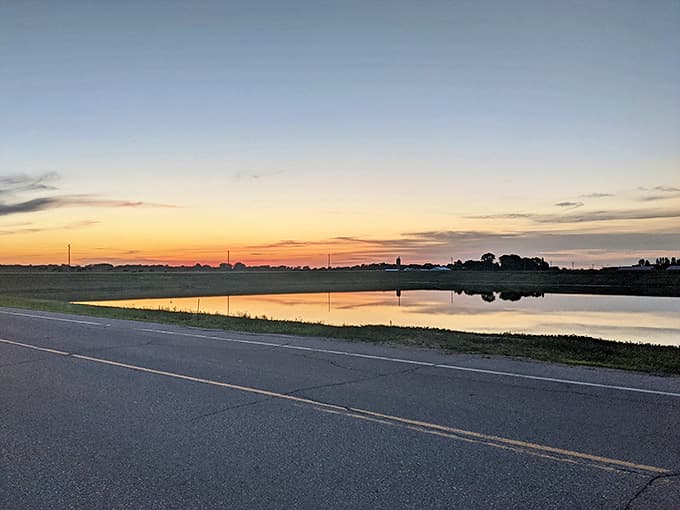 Sunset paints the countryside in watercolor hues, turning an ordinary Minnesota road into a pathway to serenity that calms even the most frazzled city nerves.