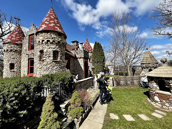 The castle's impressive stone facade catches golden hour light, transforming ordinary suburban surroundings into a scene worthy of a European postcard.
