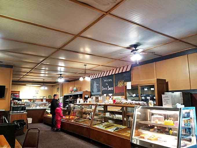 Inside, time stands still as glass cases showcase decades of baking tradition, while the striped awning adds a touch of nostalgic charm.