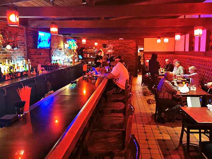 Warm lighting bathes the interior in a cozy glow, where the bar beckons with promises of perfectly poured pints and friendly conversation.