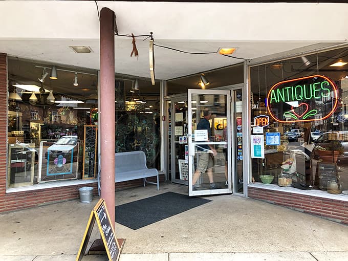 Midtown Antique Mall's welcoming entrance beckons treasure hunters with its glowing "ANTIQUES" sign – the gateway to a world of vintage discoveries.