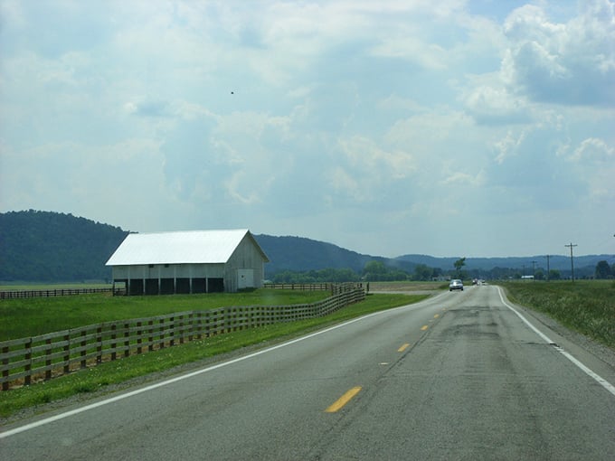 Classic Ohio countryside unfolds along Route 50, where white barns and green fields create a timeless pastoral scene straight from an American painting.