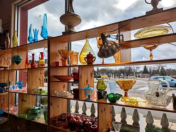 Colorful glassware catches the light at Little Red Schoolhouse, creating a rainbow display that's as beautiful as it is historically significant.
