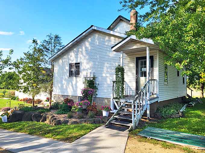 That quaint white building surrounded by greenery looks like it wandered out of a storybook and decided to start baking.