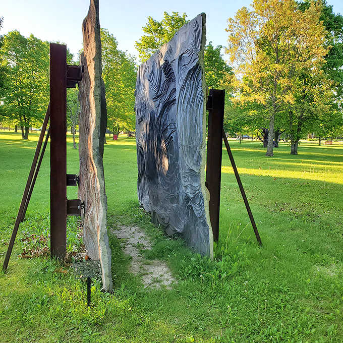 Abstract stone slabs create a mysterious passageway, inviting visitors to step between worlds while contemplating what lies on the other side.
