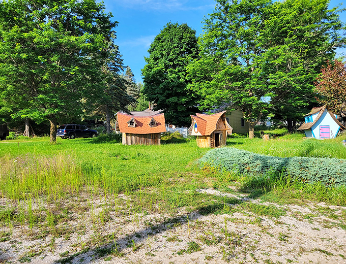 A collection of gnome dwellings nestled among the greenery, each with its own quirky personality and architectural flair.