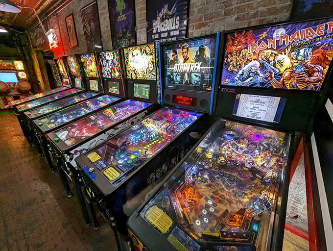 Row after glorious row of arcade cabinets stand at attention, their screens glowing with pixelated promises of high-score glory.