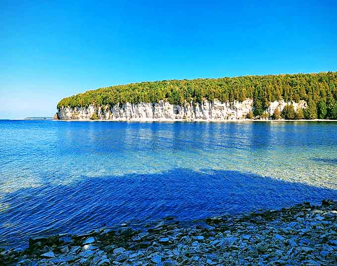 Limestone cliffs meet crystal waters at Fayette's shoreline &ndash; Mother Nature's dramatic frame for this historical treasure.